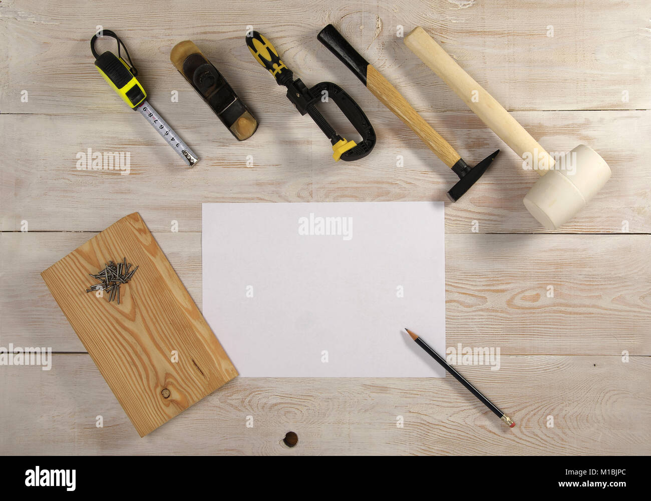 a white sheet of paper and a pencil to sketch, the top view on wooden ...