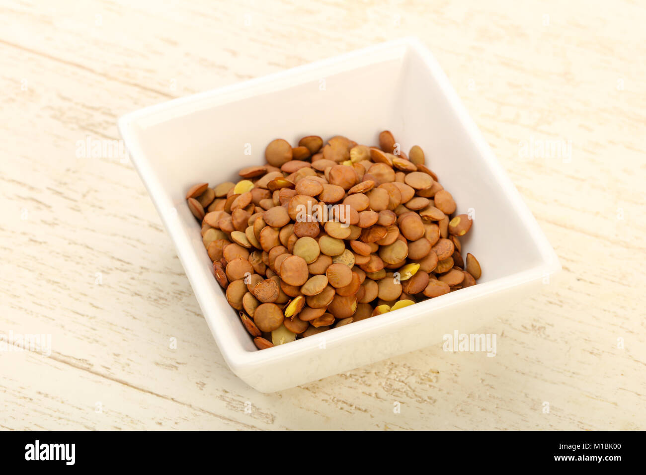Raw lentils in the bowl ready for cooking Stock Photo - Alamy