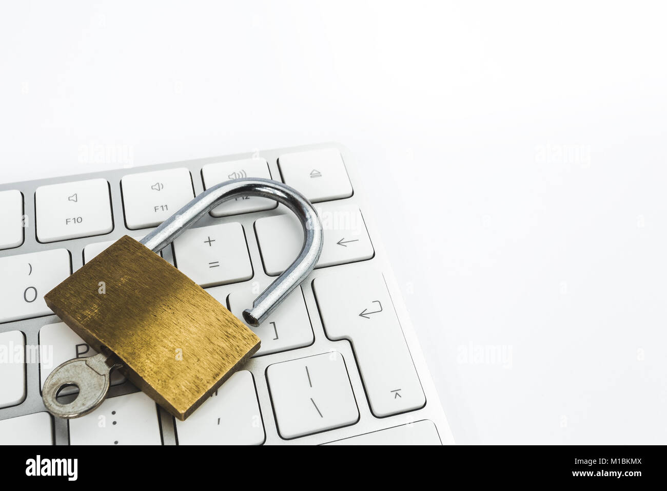 Background image of golden metal lock on keyboard Stock Photo - Alamy