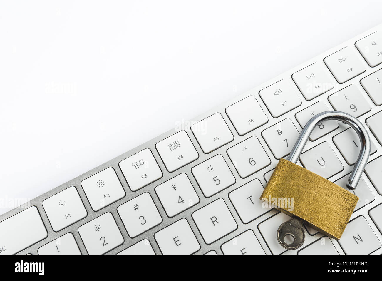 Background image of golden metal lock on keyboard Stock Photo - Alamy