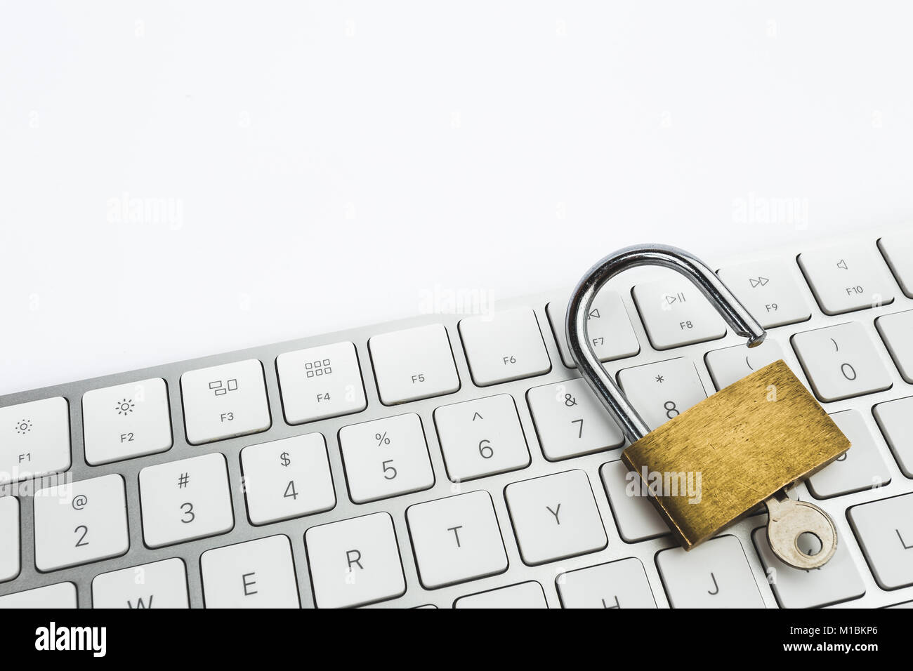 Background image of golden metal lock on keyboard Stock Photo - Alamy