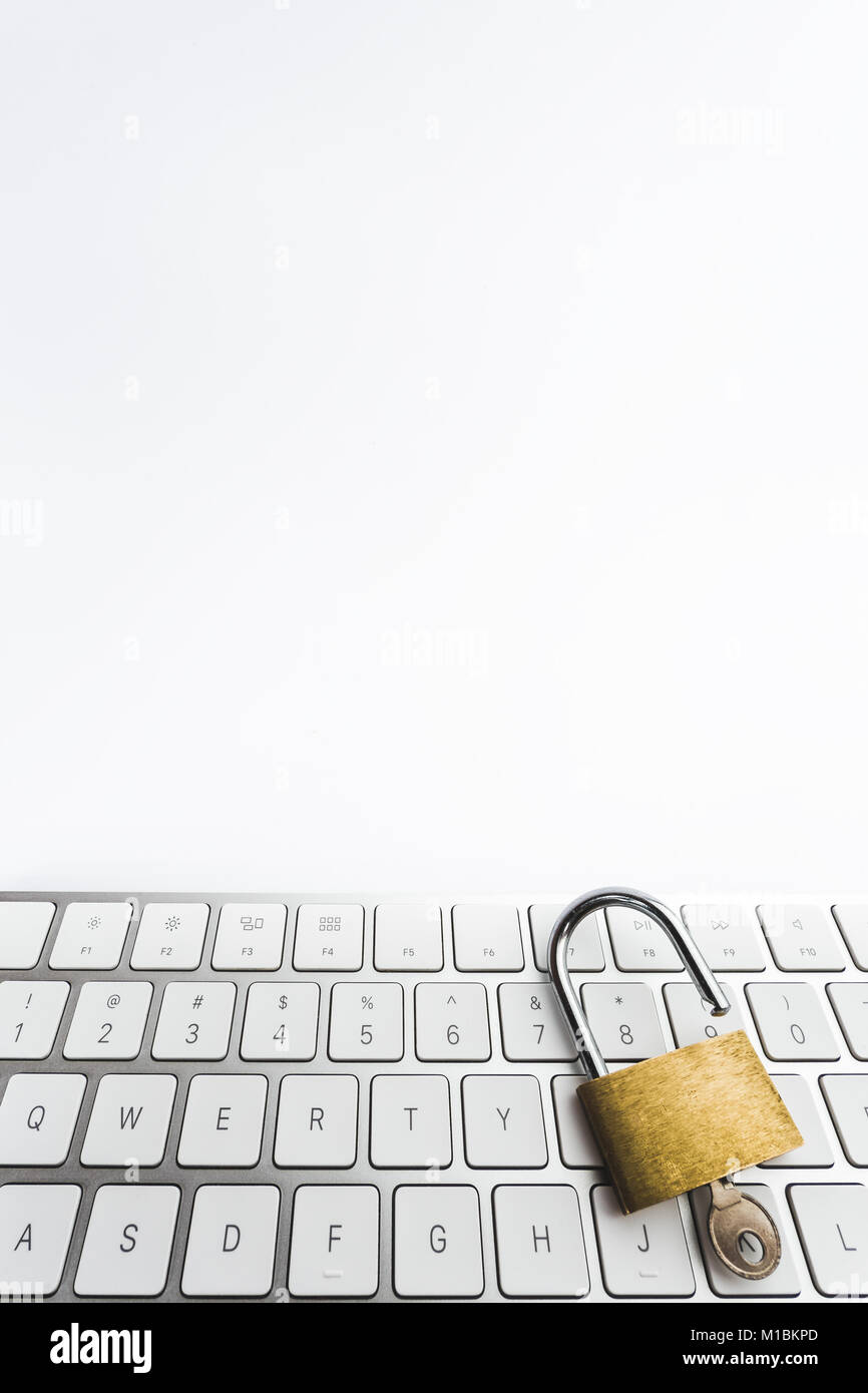 Background image of golden metal lock on keyboard Stock Photo - Alamy