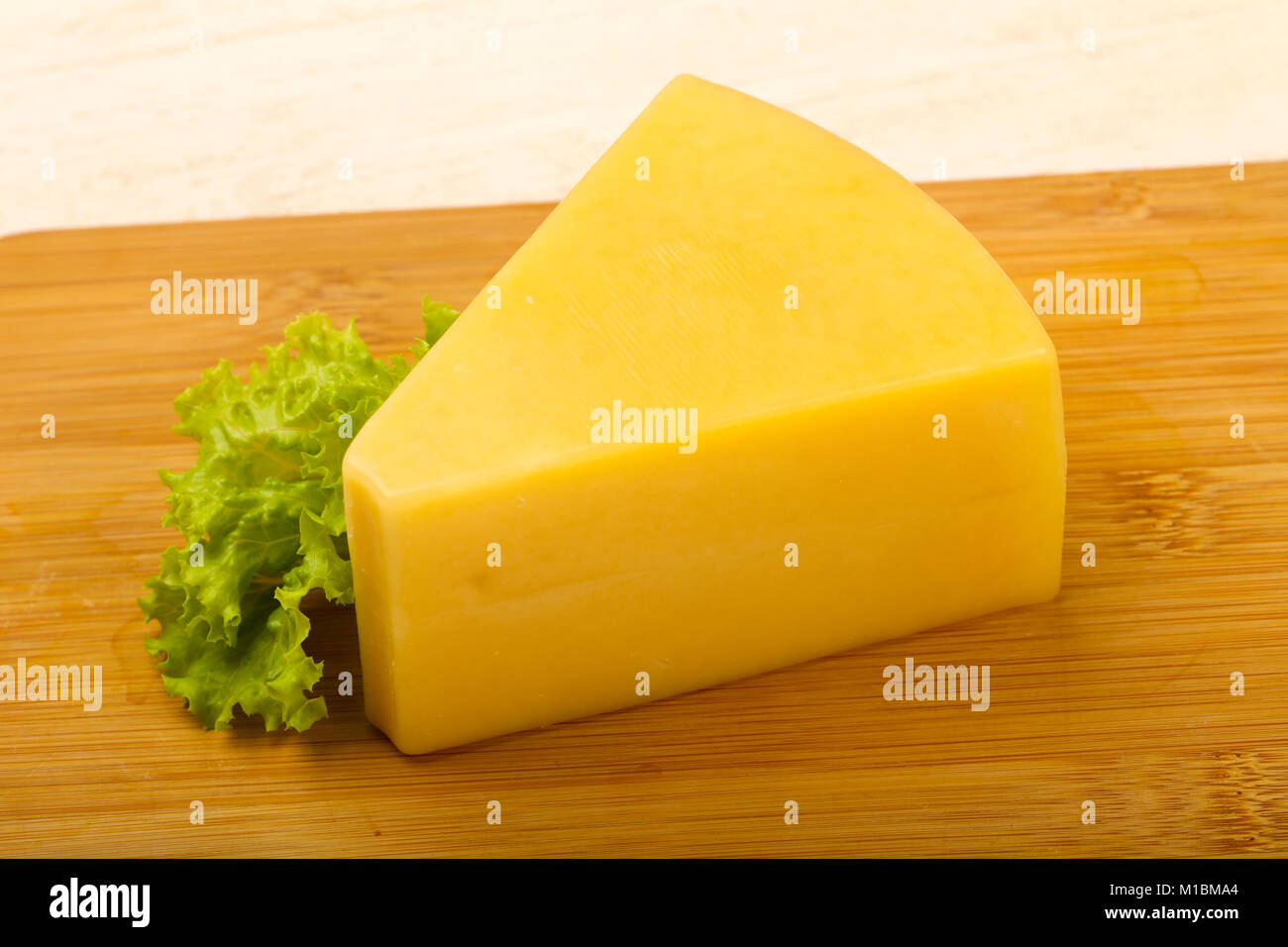 Parmesan cheese triangle Stock Photo - Alamy