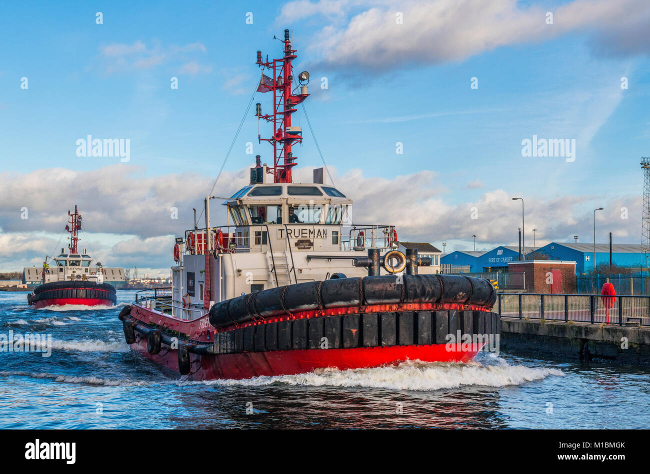 Two Tugs coming into Cardiff Dock to tow out a Naval Vessel Stock Photo ...
