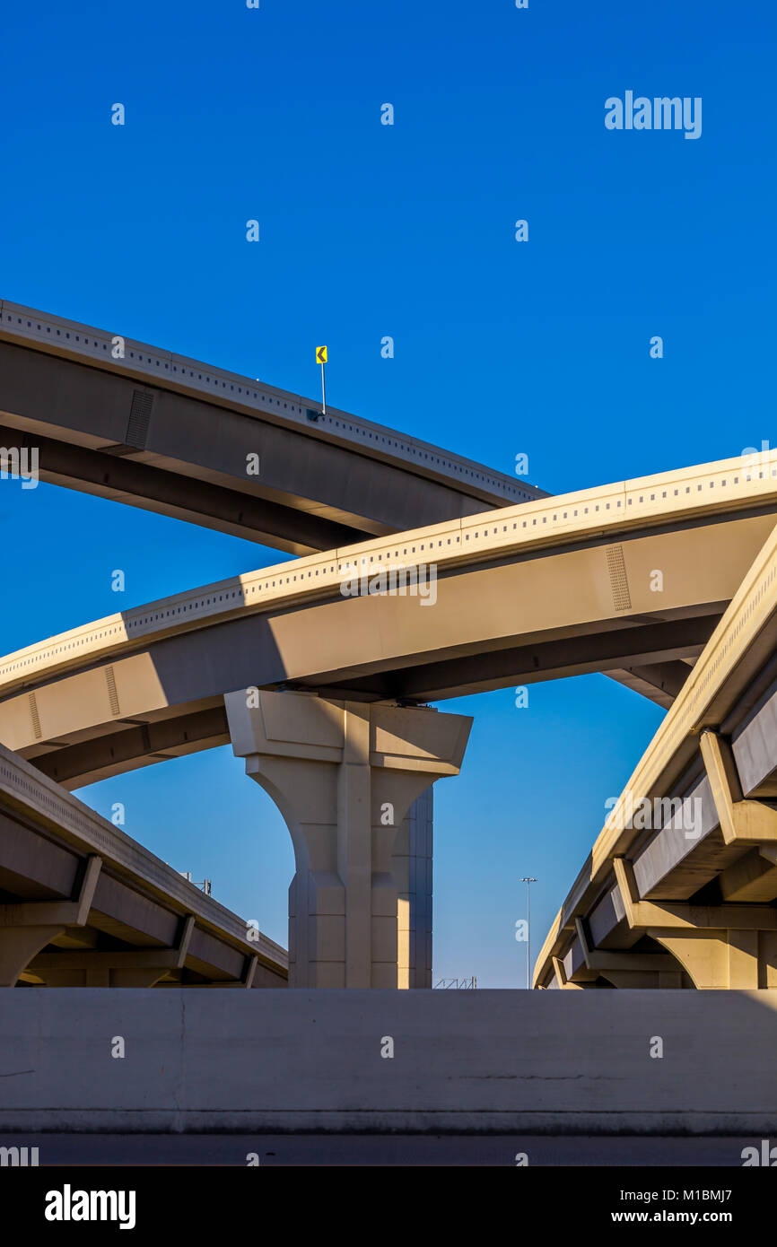 Section of elevated highway with several levels against a bright blue ...