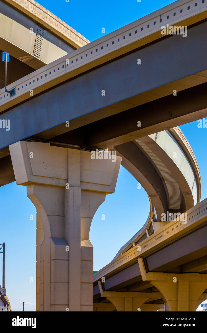 Section of elevated highway with several levels against a bright blue ...