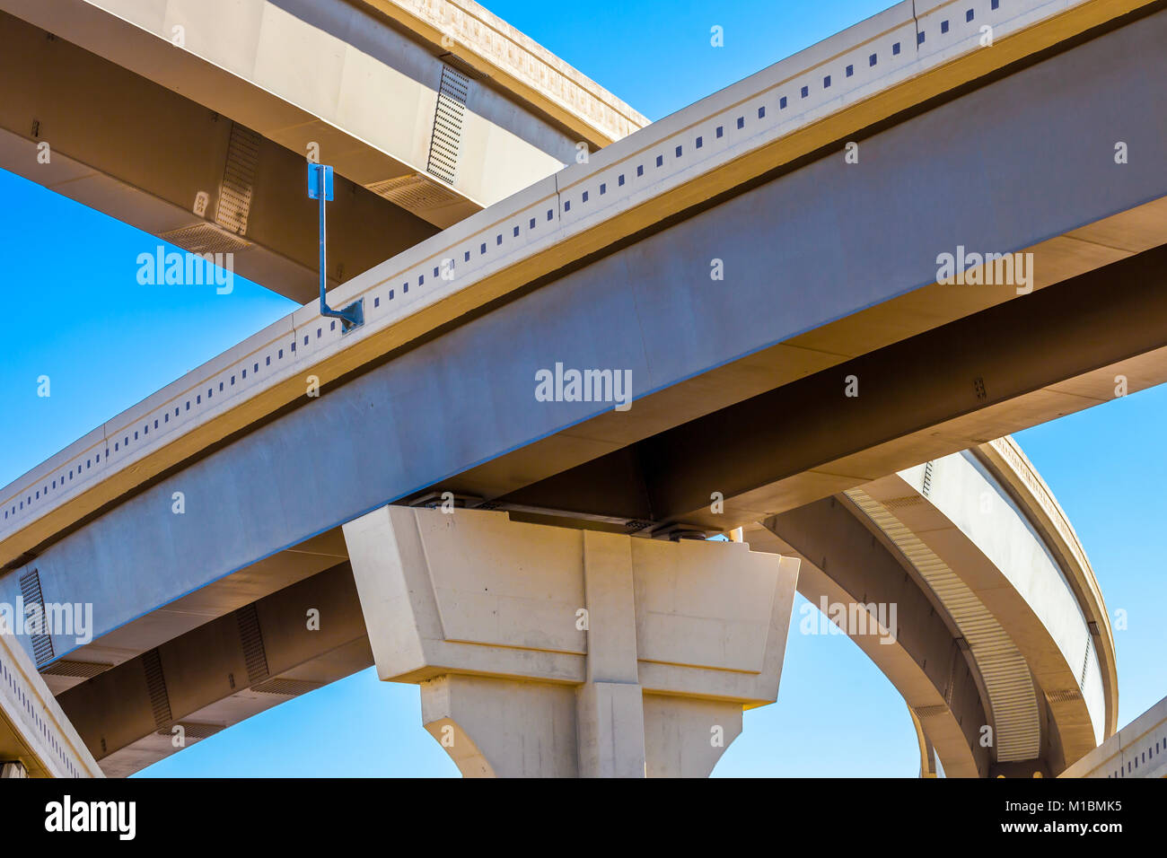 Section of elevated highway with several levels against a bright blue ...