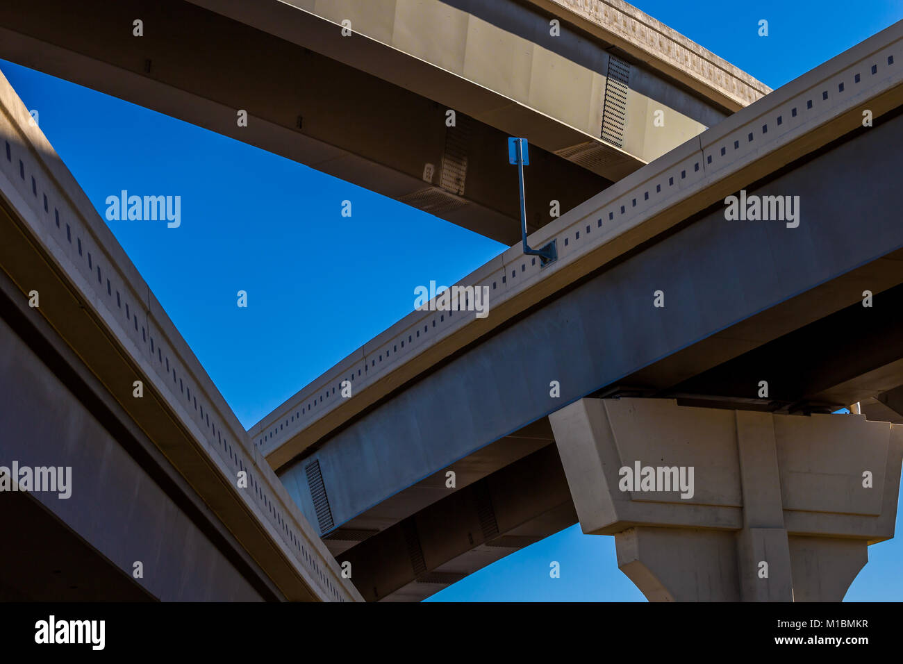 Section of elevated highway with several levels against a bright blue ...