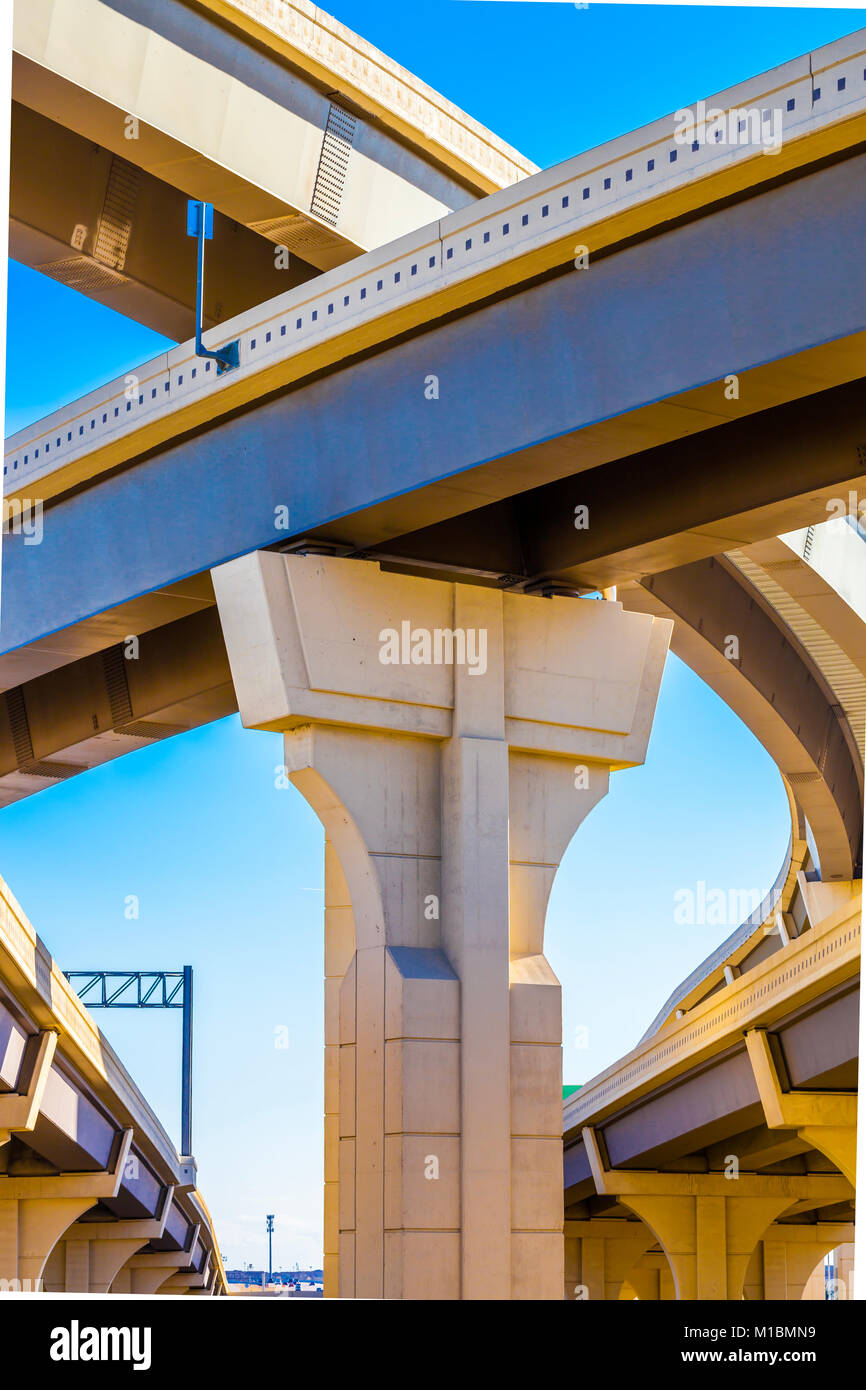 Section of elevated highway with several levels against a bright blue ...