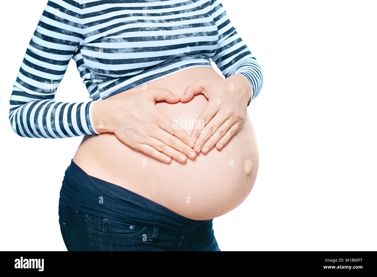Pregnant Woman Holding her Hands in a Heart Shape on her Baby Bump ...