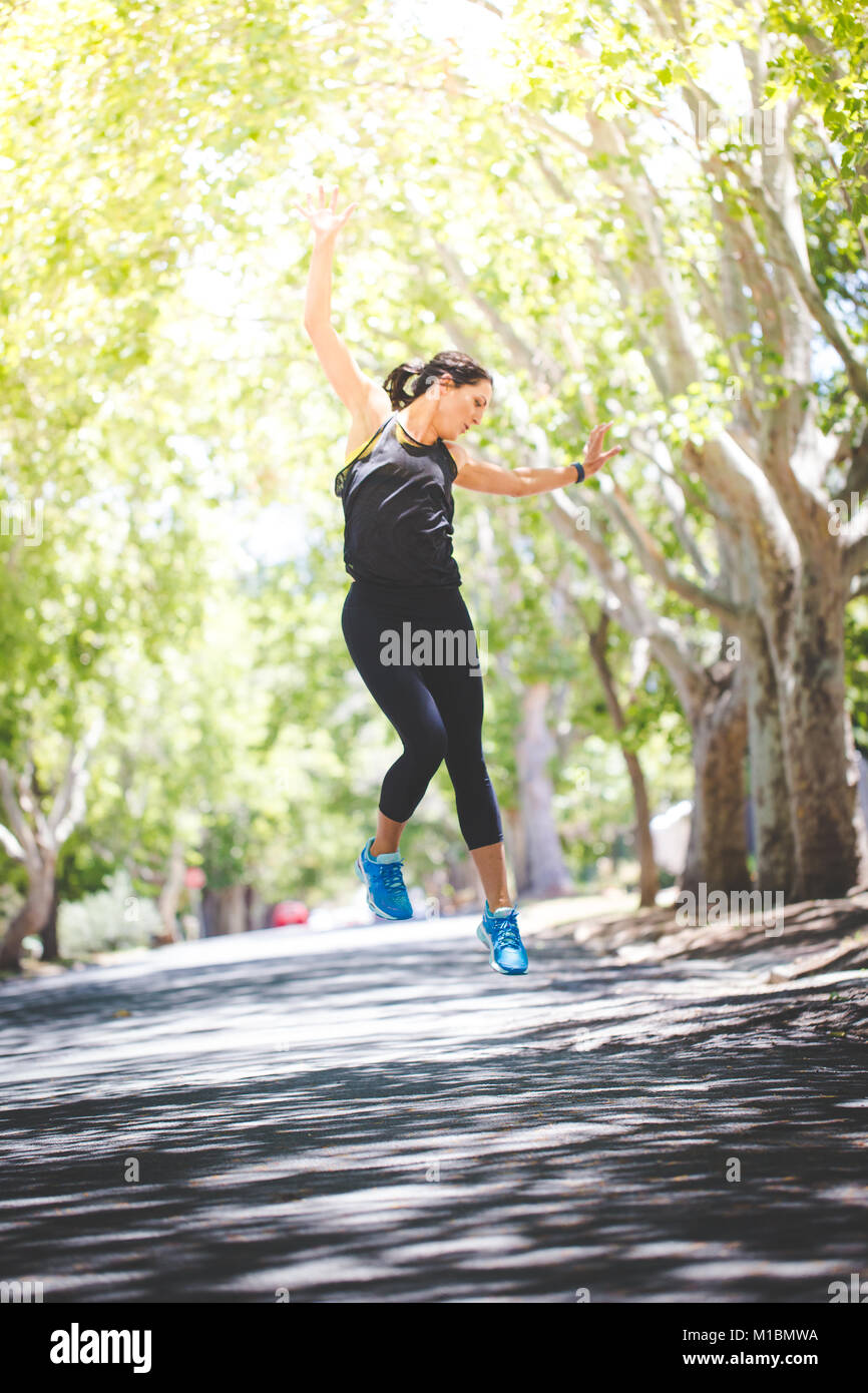 Beautiful brunette female fitness model running / stretching ...