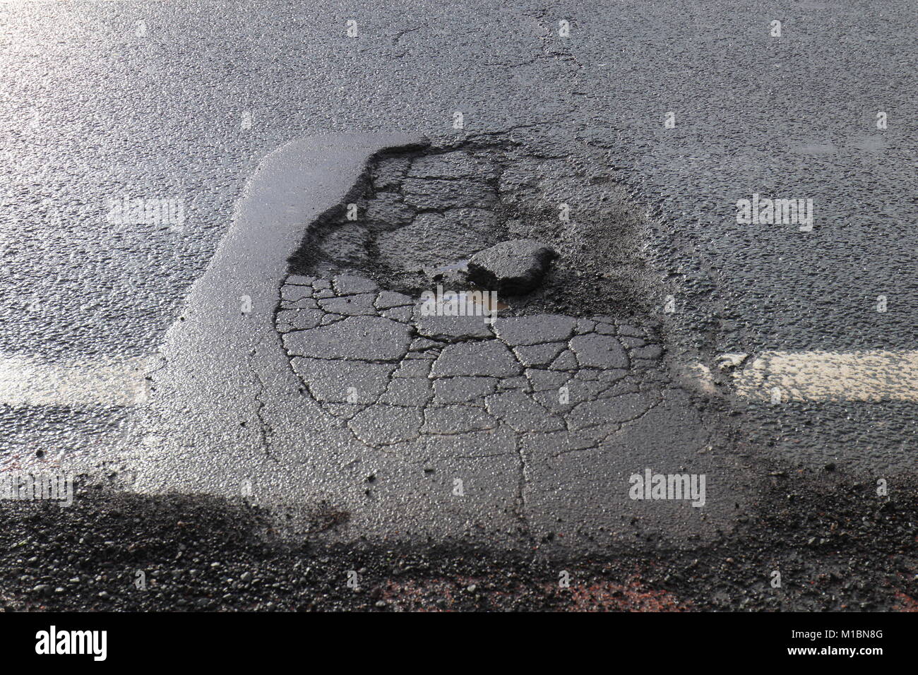 Pothole In The Road Stock Photo - Alamy