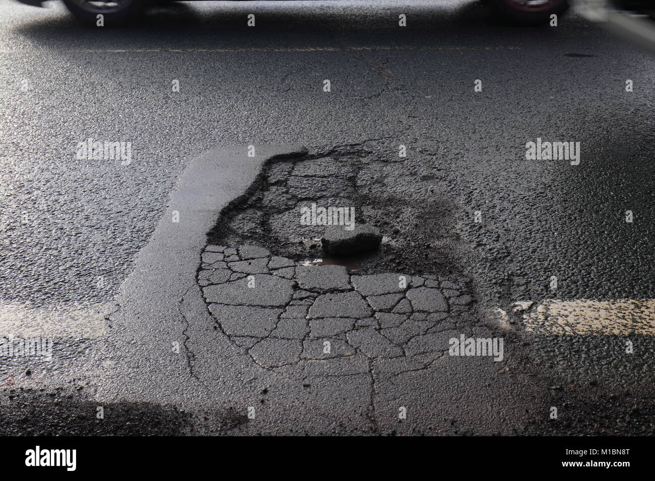 Pothole In The Road Stock Photo - Alamy
