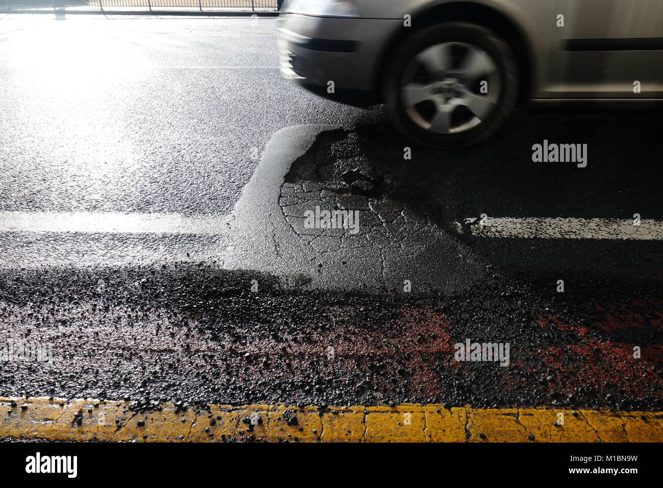 Pothole In The Road Stock Photo - Alamy