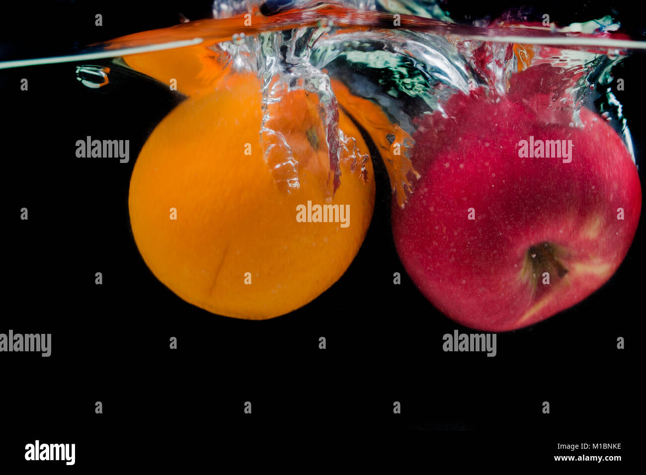 fruit falling through water Stock Photo - Alamy