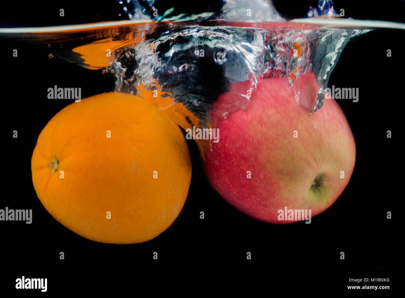 fruit falling through water Stock Photo - Alamy