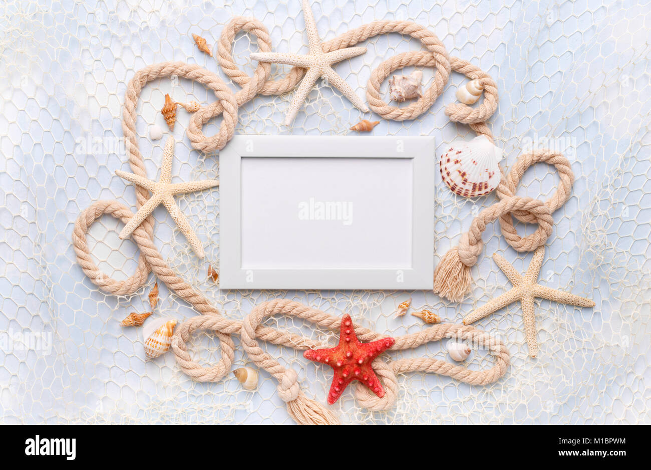 Summer Holiday concept with star fish, sea shells, fishing net and rope ...