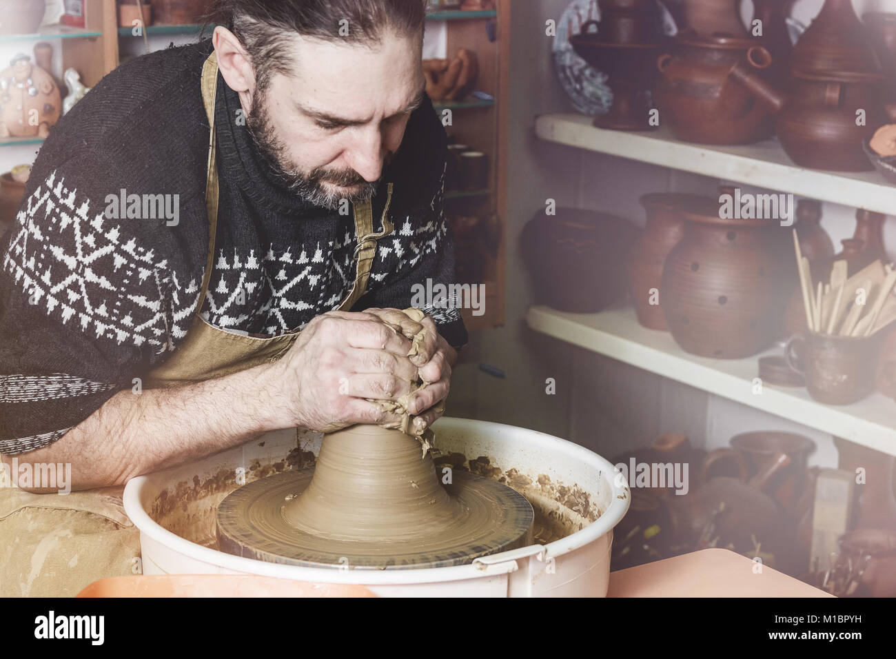 elderly man making pot using pottery wheel in studio Stock Photo - Alamy