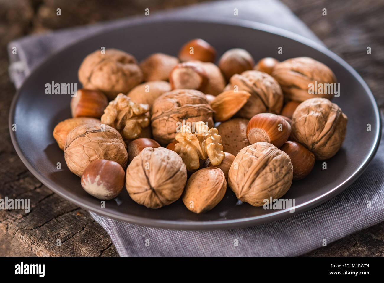 Mixed Nuts on Rustic Wooden Table Stock Photo - Alamy