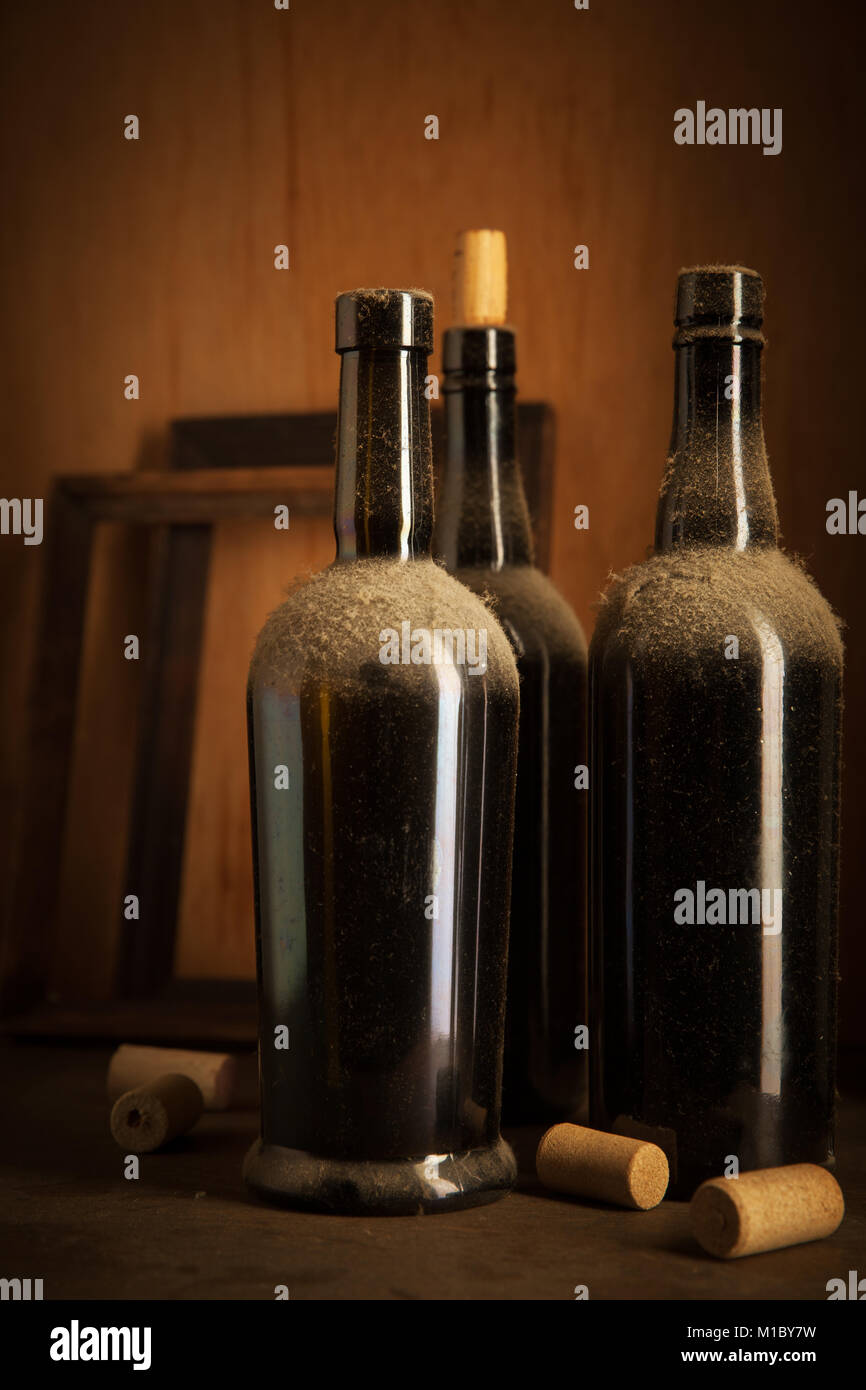 Still-life with three old dusty wine bottles and corks Stock Photo - Alamy