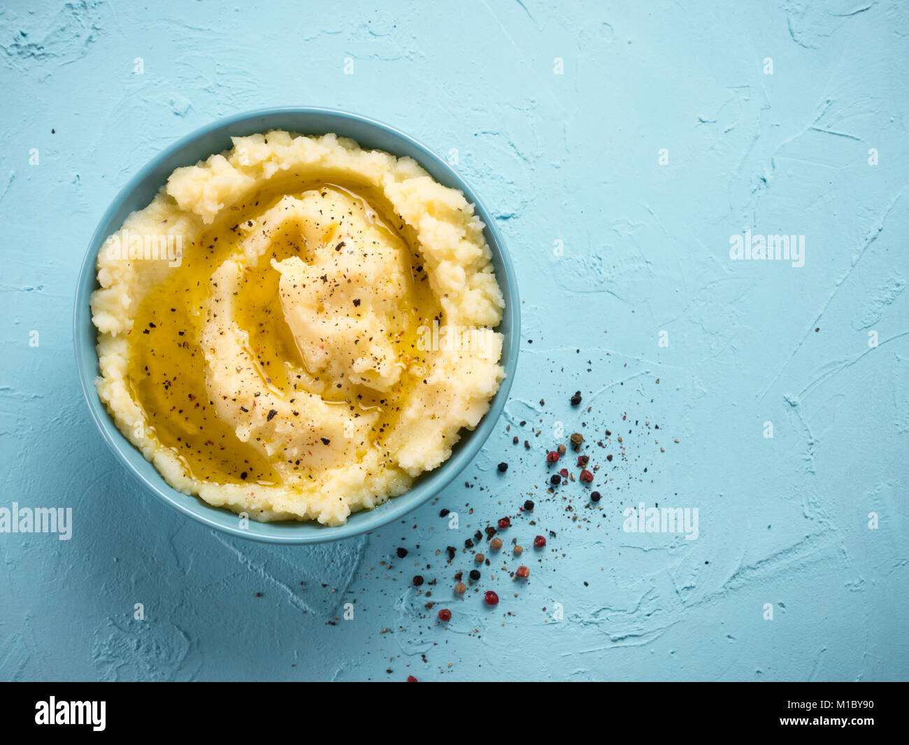 Mashed potatoes on blue concrete background Stock Photo - Alamy