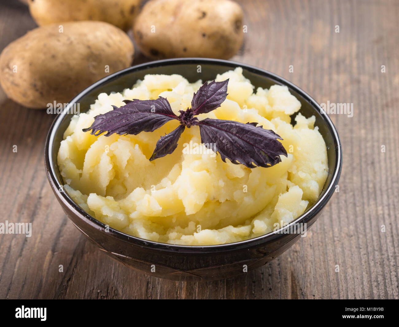 Mashed potatoes on wooden background Stock Photo - Alamy