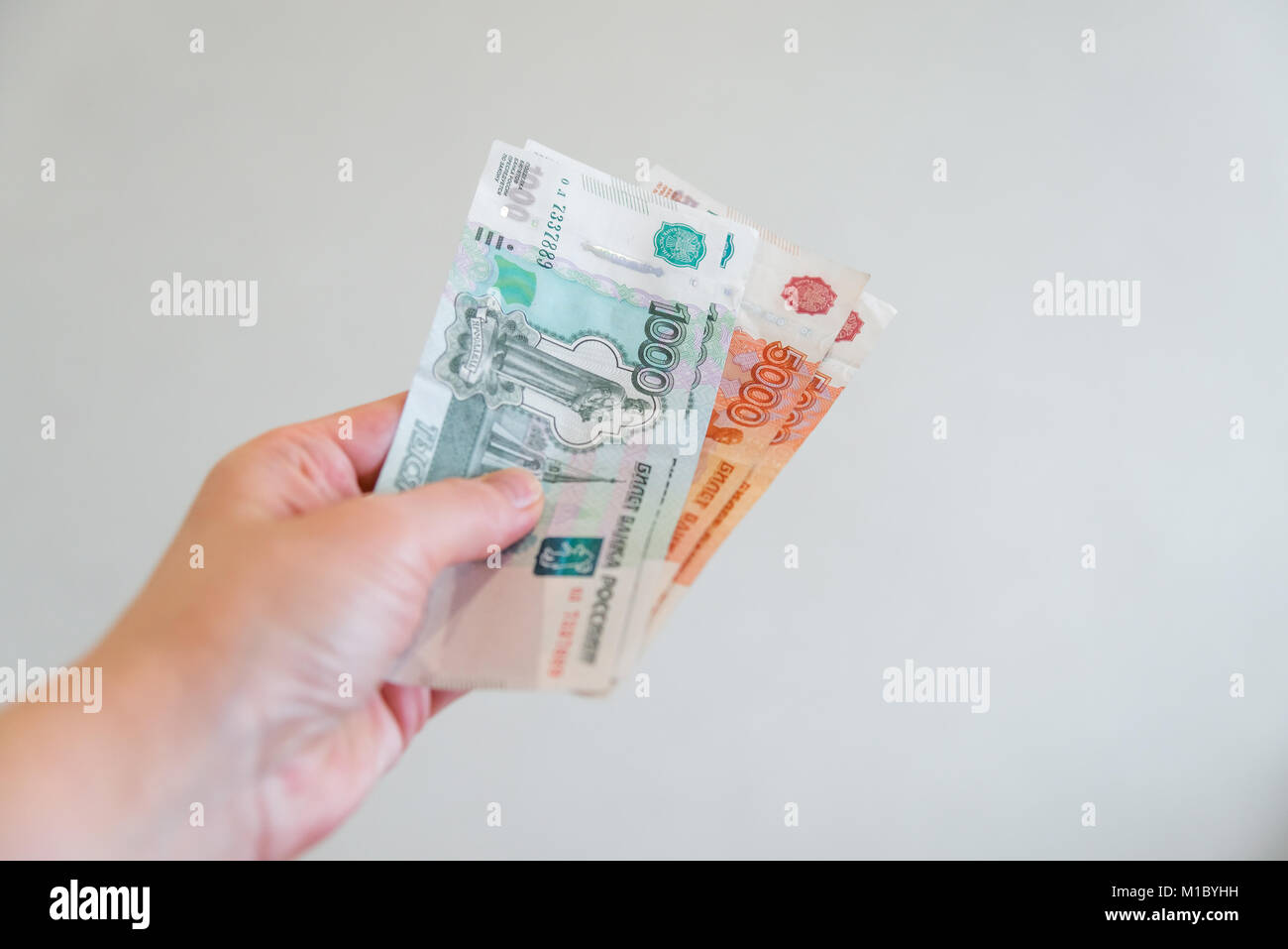a woman's hand holds a five thousandth note. Russian money Stock Photo ...
