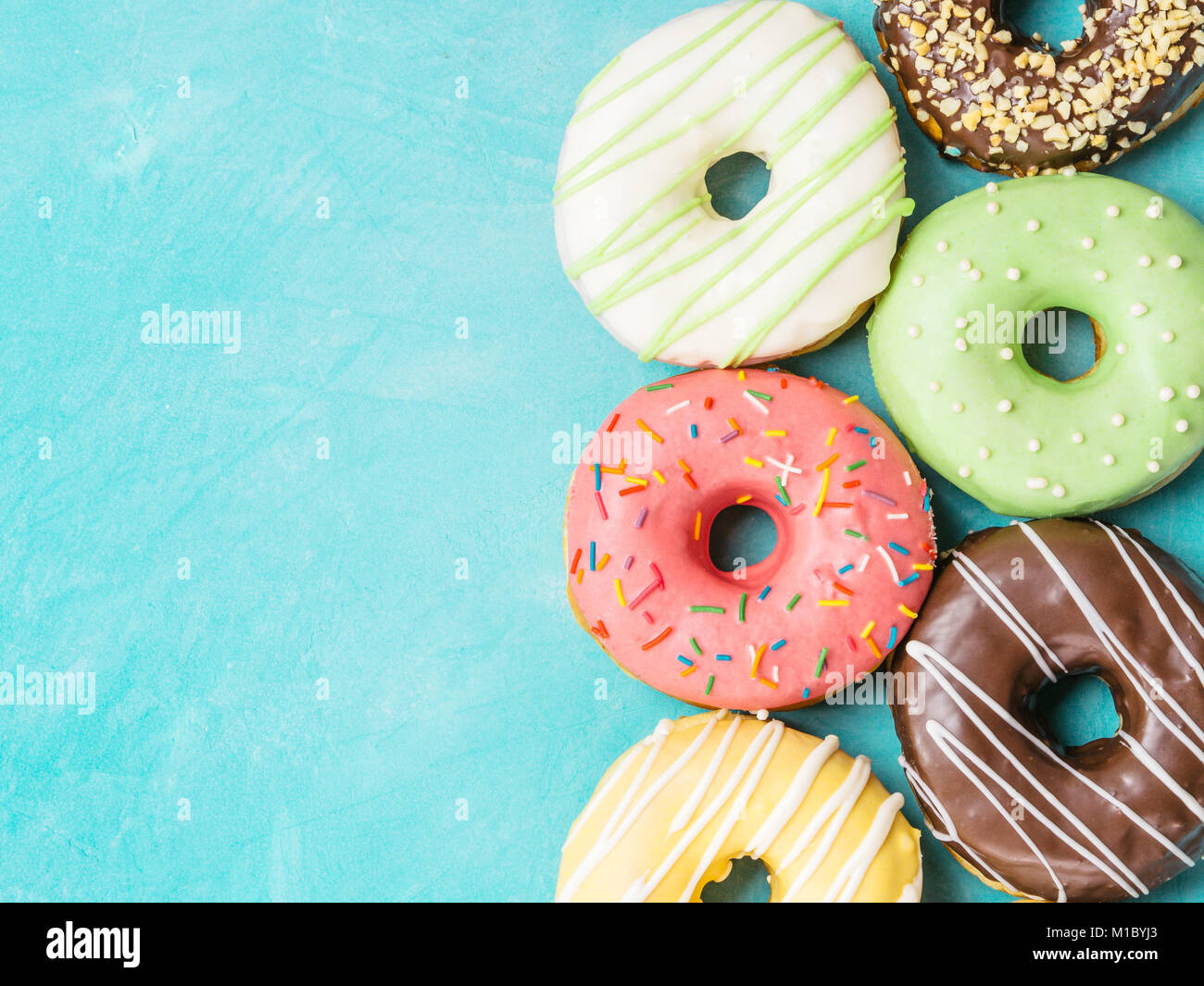 donuts on blue background , copy space, top view Stock Photo - Alamy