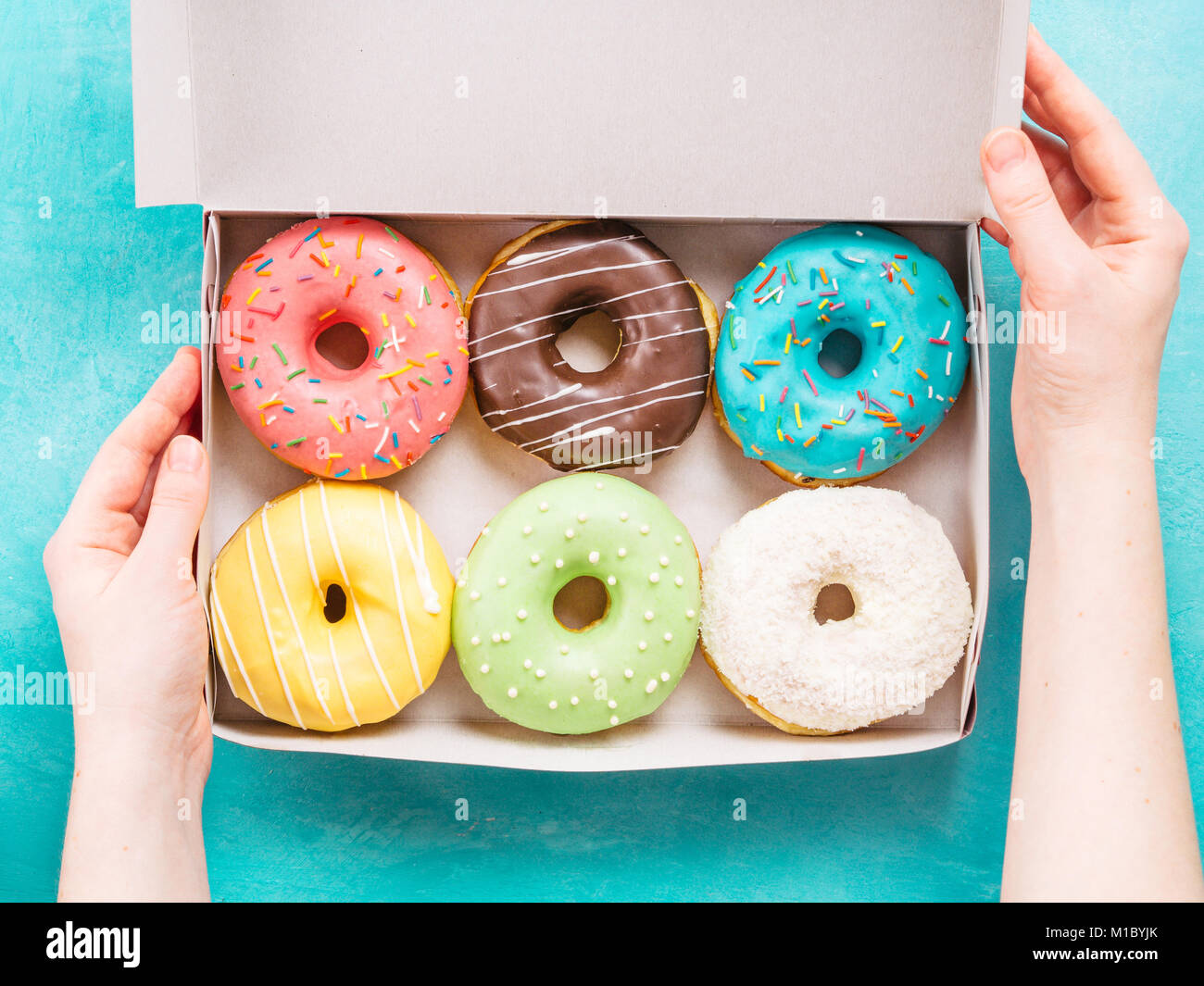 Female hands sweet donuts hi-res stock photography and images - Alamy