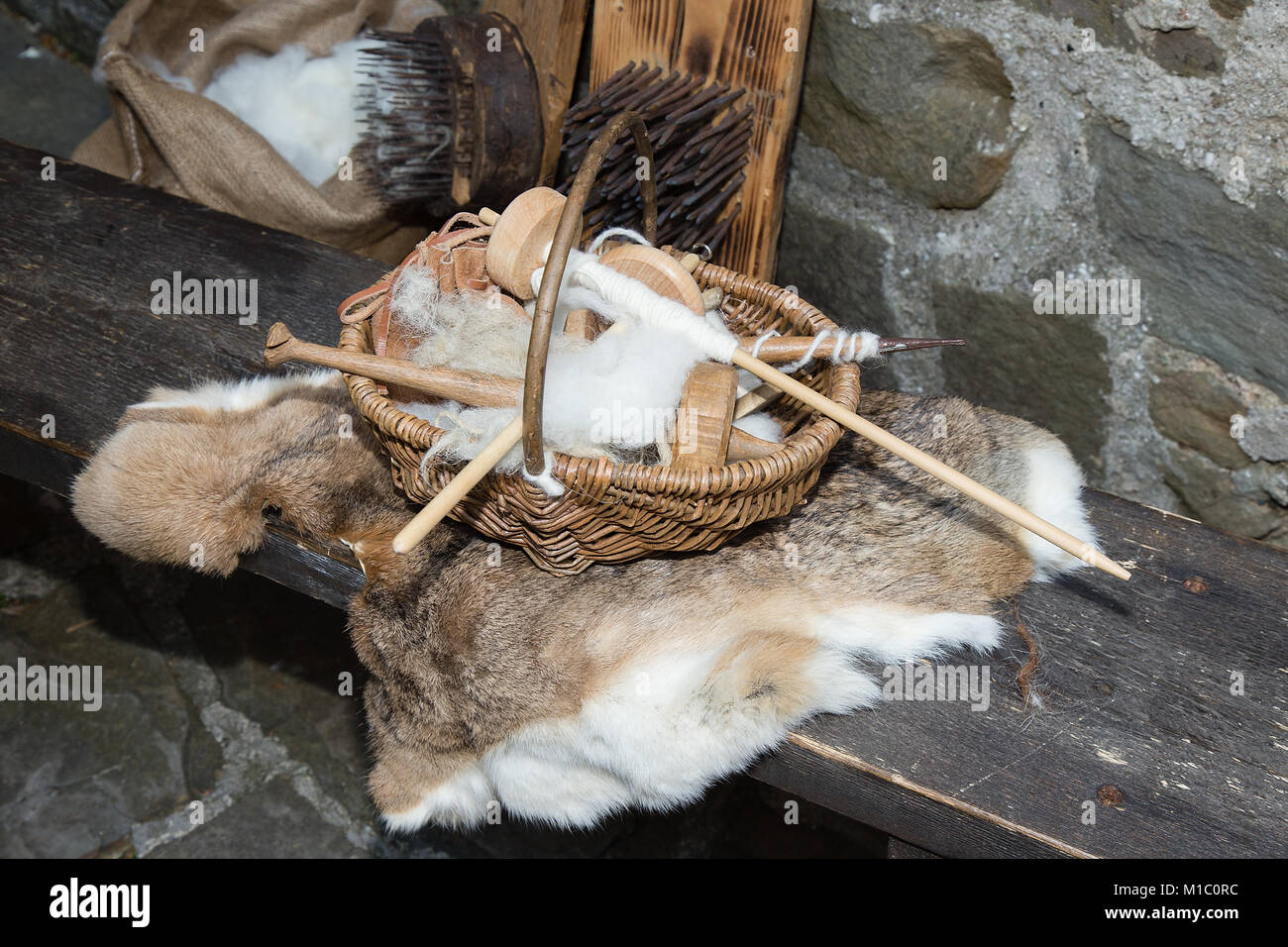 Raw Sheep Wool with Tools for spinning wool in basket Stock Photo - Alamy