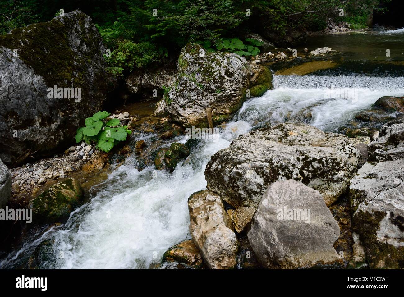 Water versus the rocks of a mountain Stock Photo - Alamy