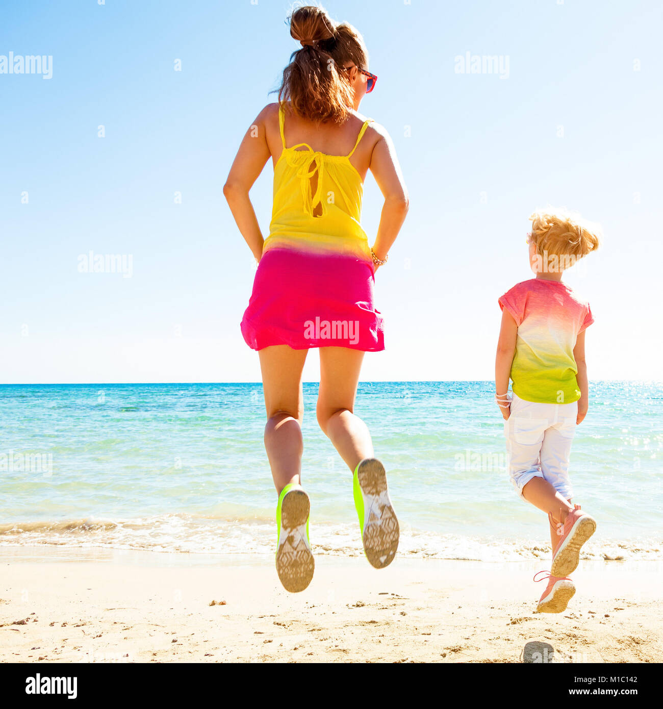Kid jumping back view hi-res stock photography and images - Alamy