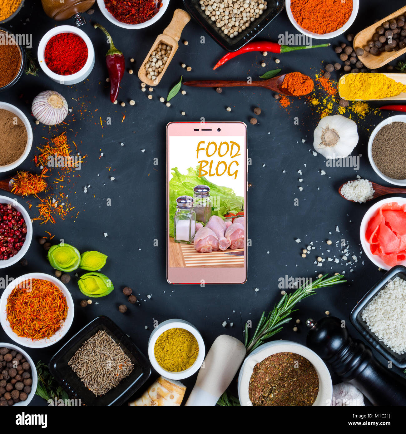 Food blog concept. Indian spices, herbs and smartphone on black ...