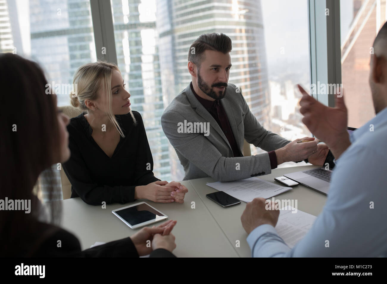 The business people sit at the table and work in the office Stock Photo ...
