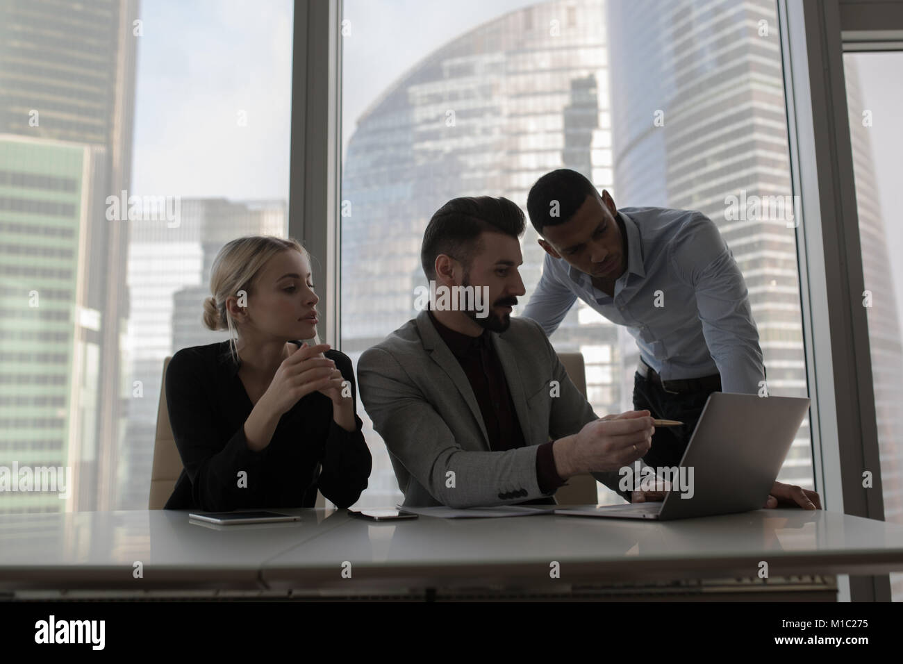 The business people sit at the table and work in the office Stock Photo ...