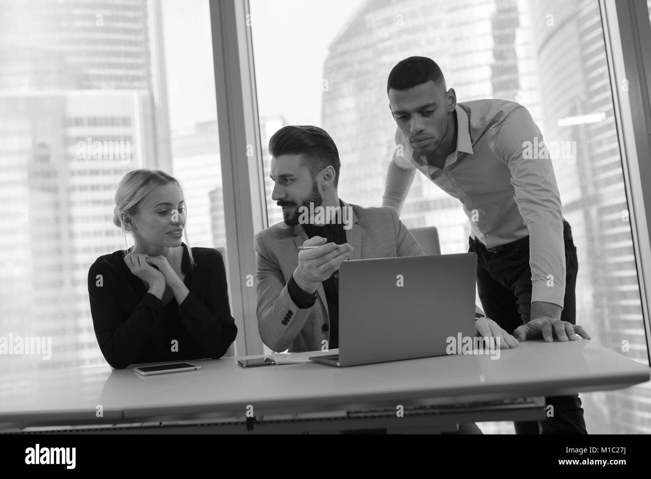 The business people sit at the table and work in the office Stock Photo ...
