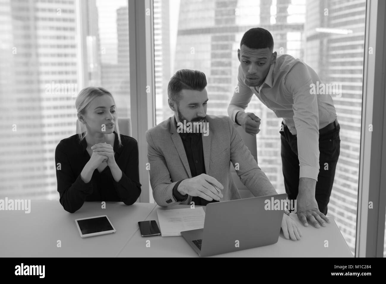 The business people sit at the table and work in the office Stock Photo ...
