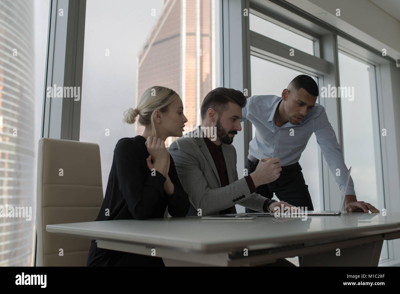 The business people sit at the table and work in the office Stock Photo ...