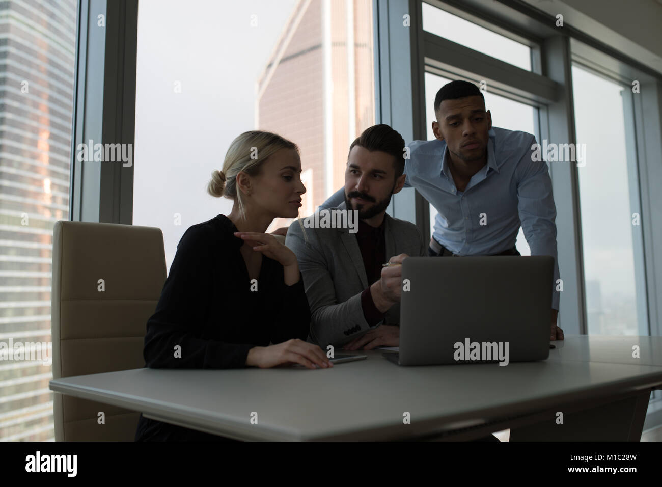 The business people sit at the table and work in the office Stock Photo ...
