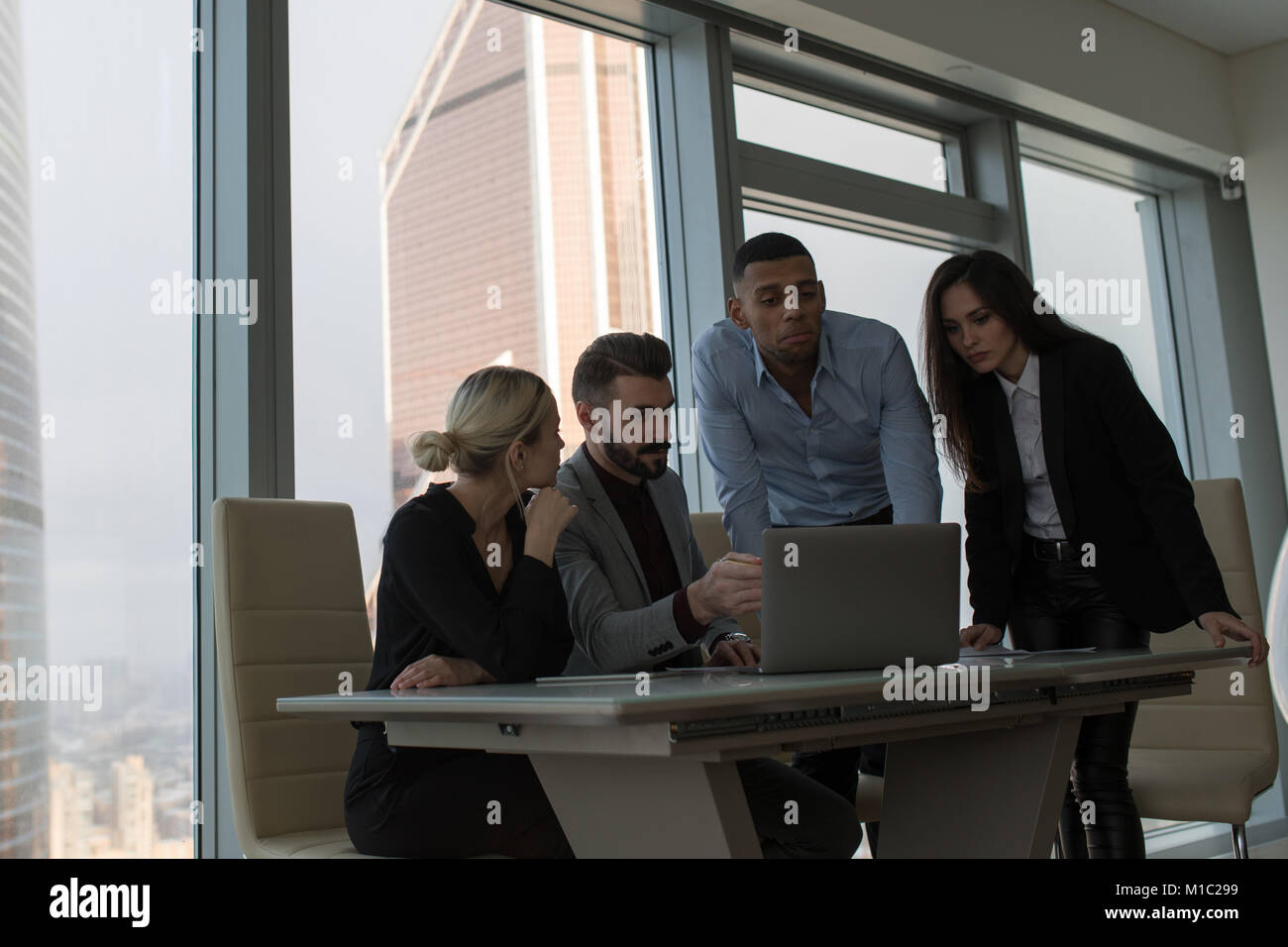 The business people sit at the table and work in the office Stock Photo ...