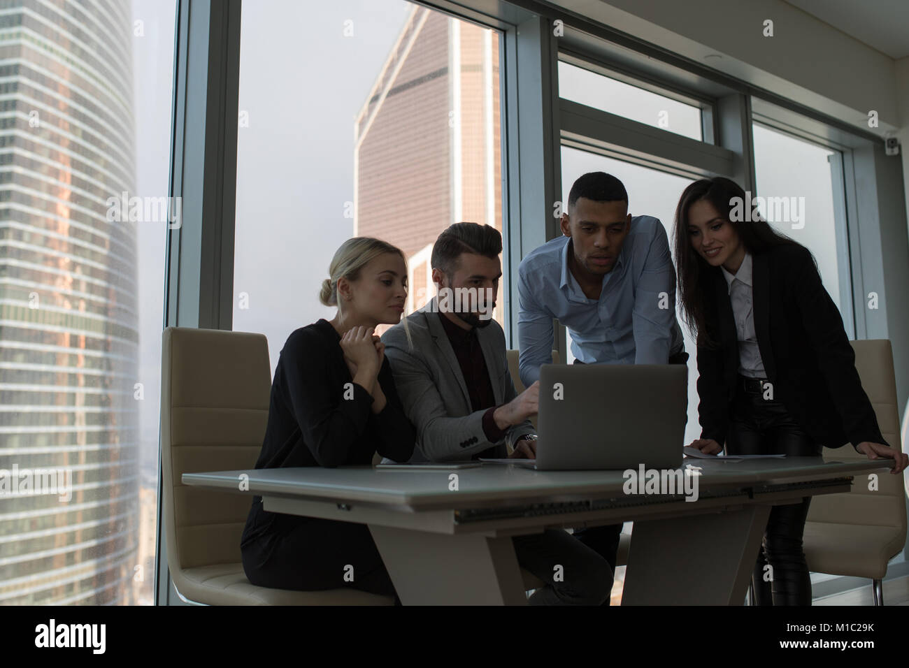 The business people sit at the table and work in the office Stock Photo ...