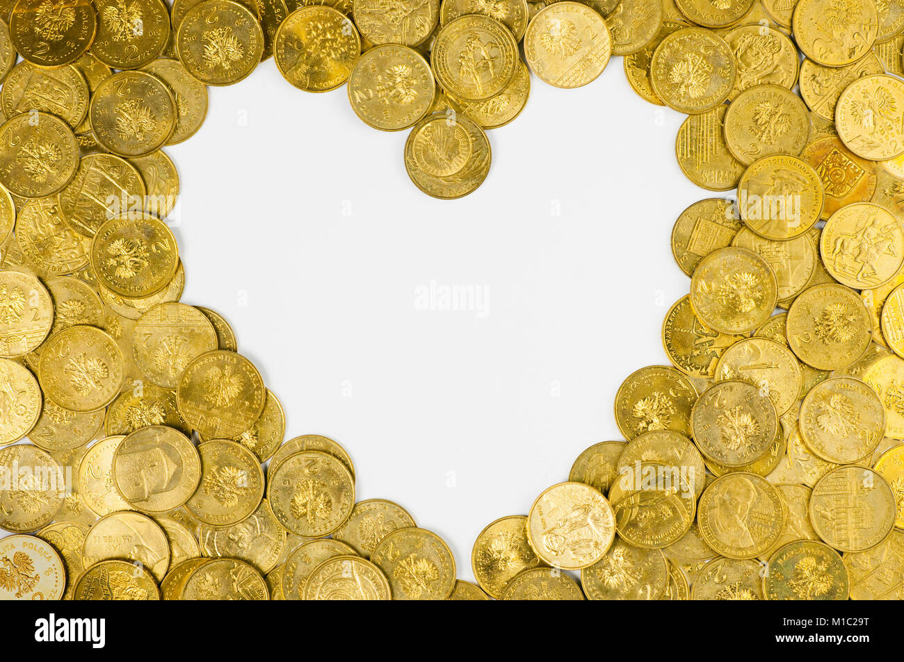 Heart shape made of gold coins Stock Photo - Alamy