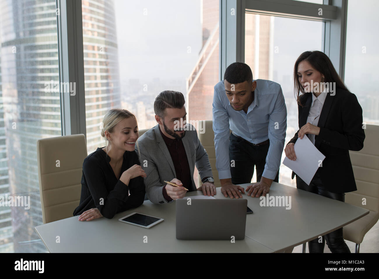 The business people sit at the table and work in the office Stock Photo ...