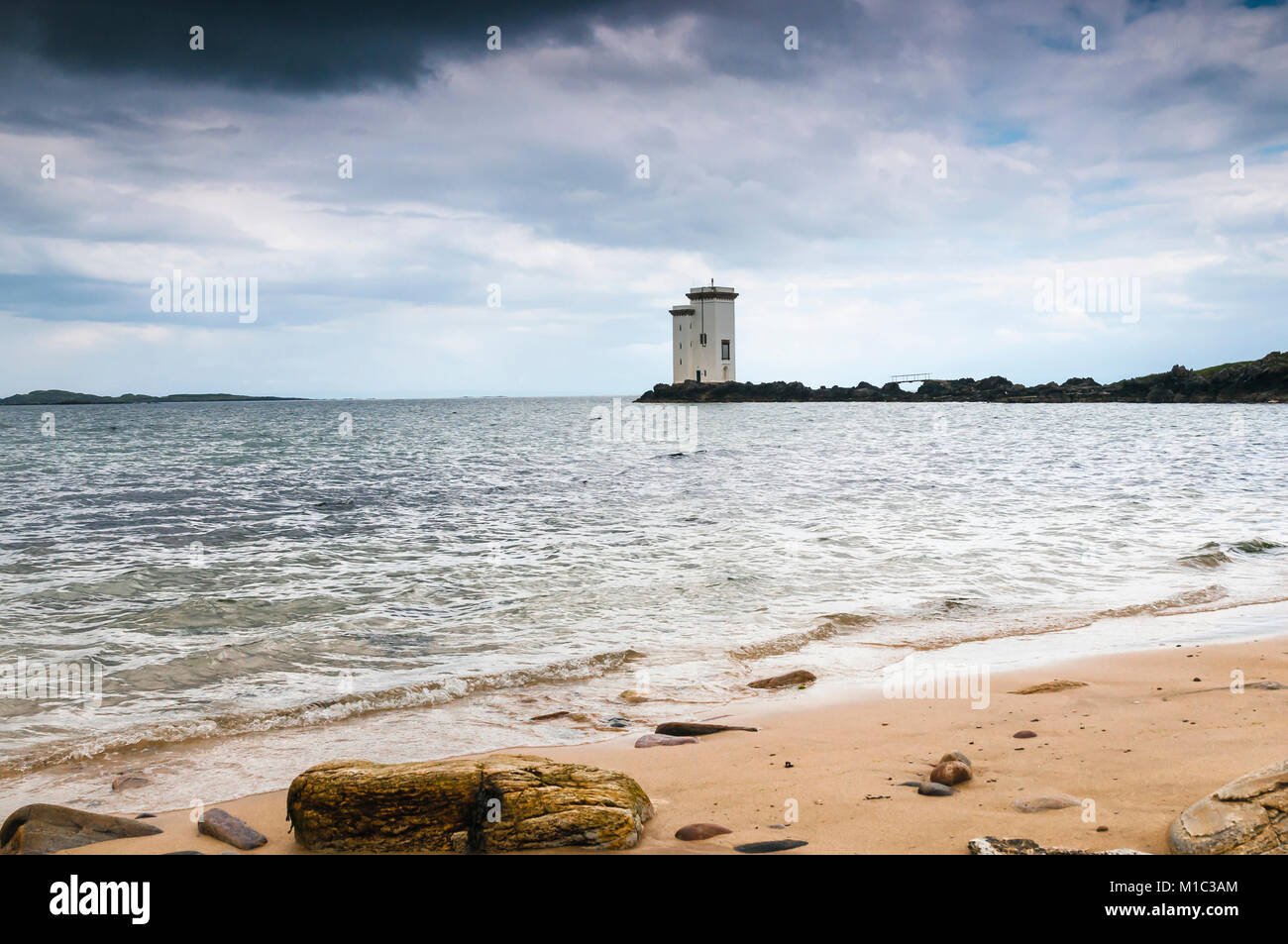 The two square towers of the Carriag Fhada Lighthouse at Port Ellen on ...