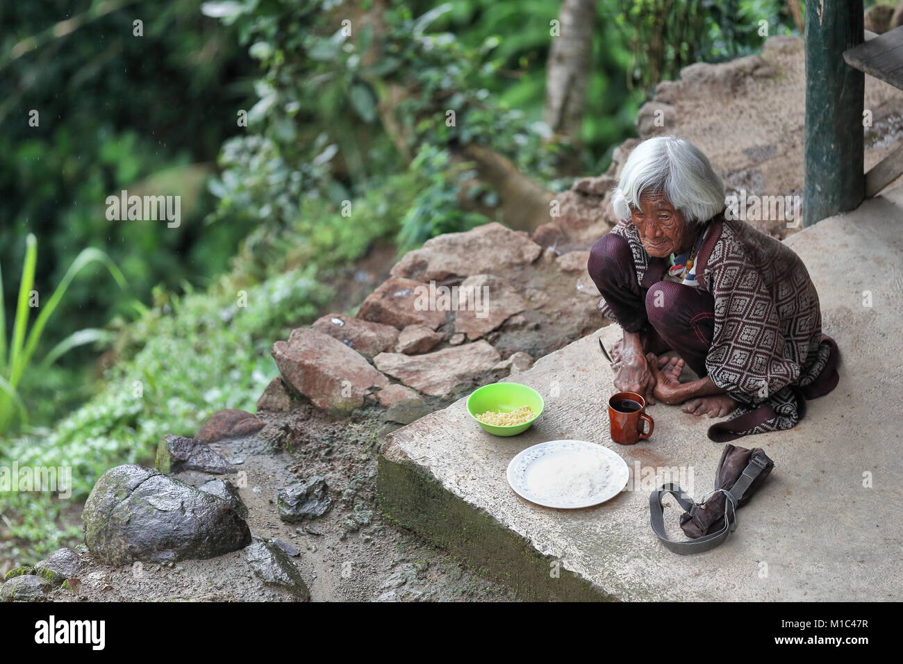 Batad, Philippines-October 7, 2016: Ifugao old woman eats rice and ...
