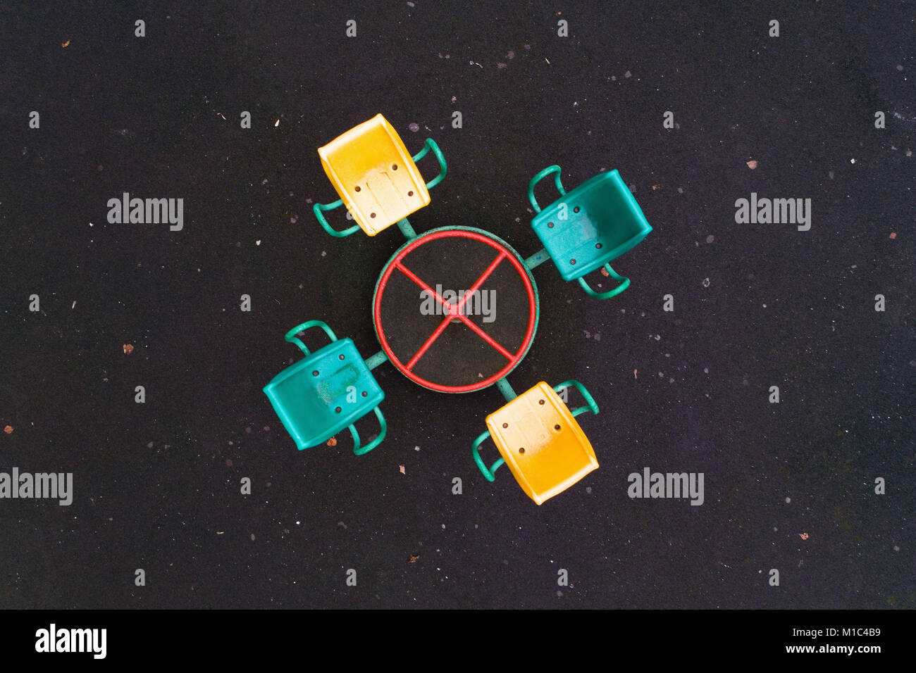 A carousel in the playground is photographed from above. Aerial ...