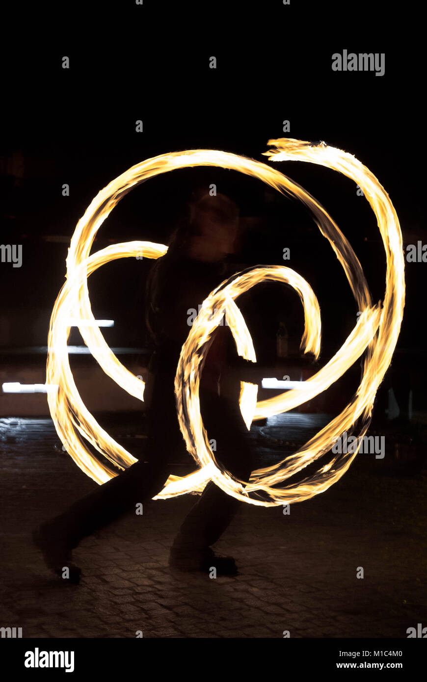 Fire spinner during show Stock Photo - Alamy