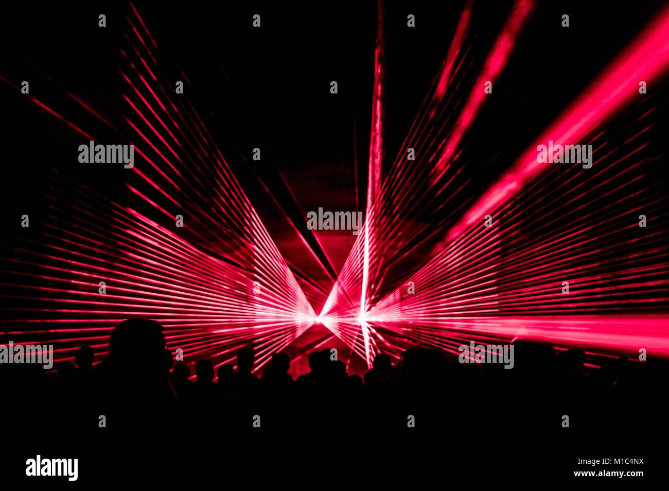 Red laser show nightlife club stage with party people crowd. Luxury ...