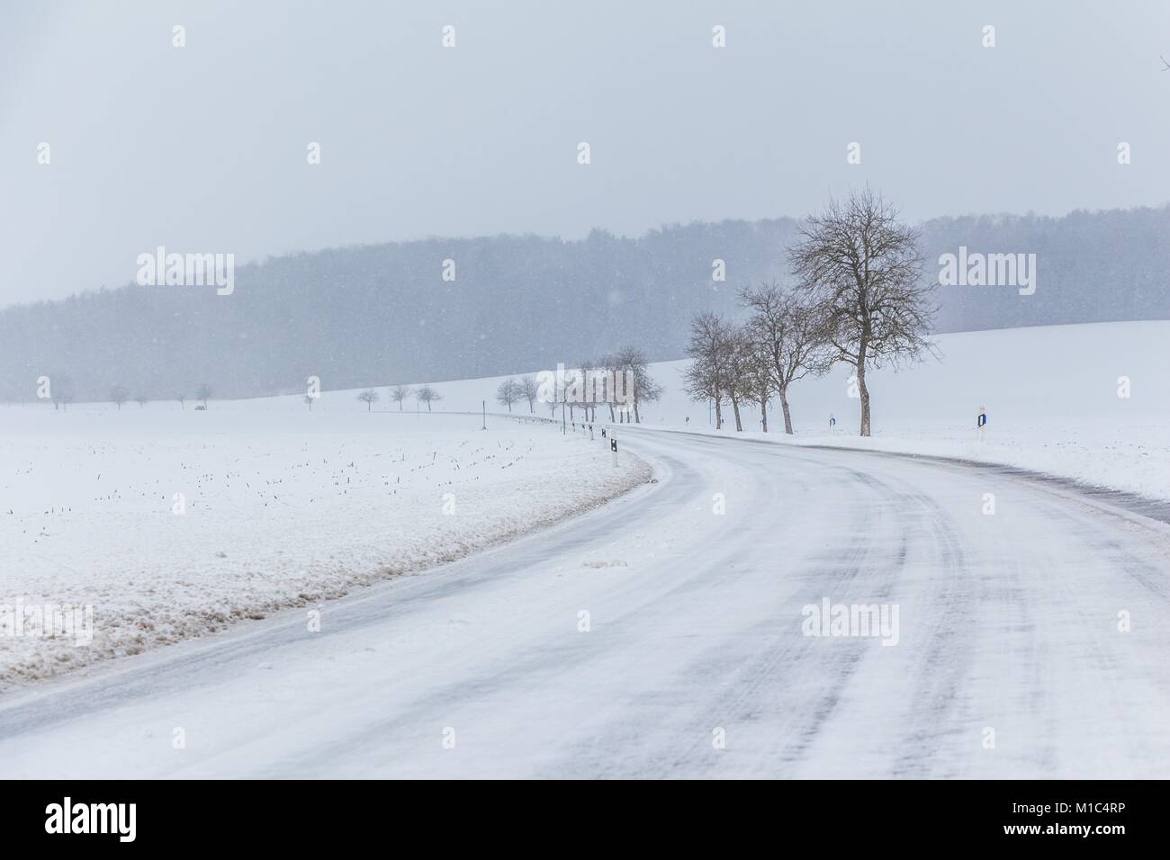 Wonderful snowy icy winter road with white snowy track. The street ...