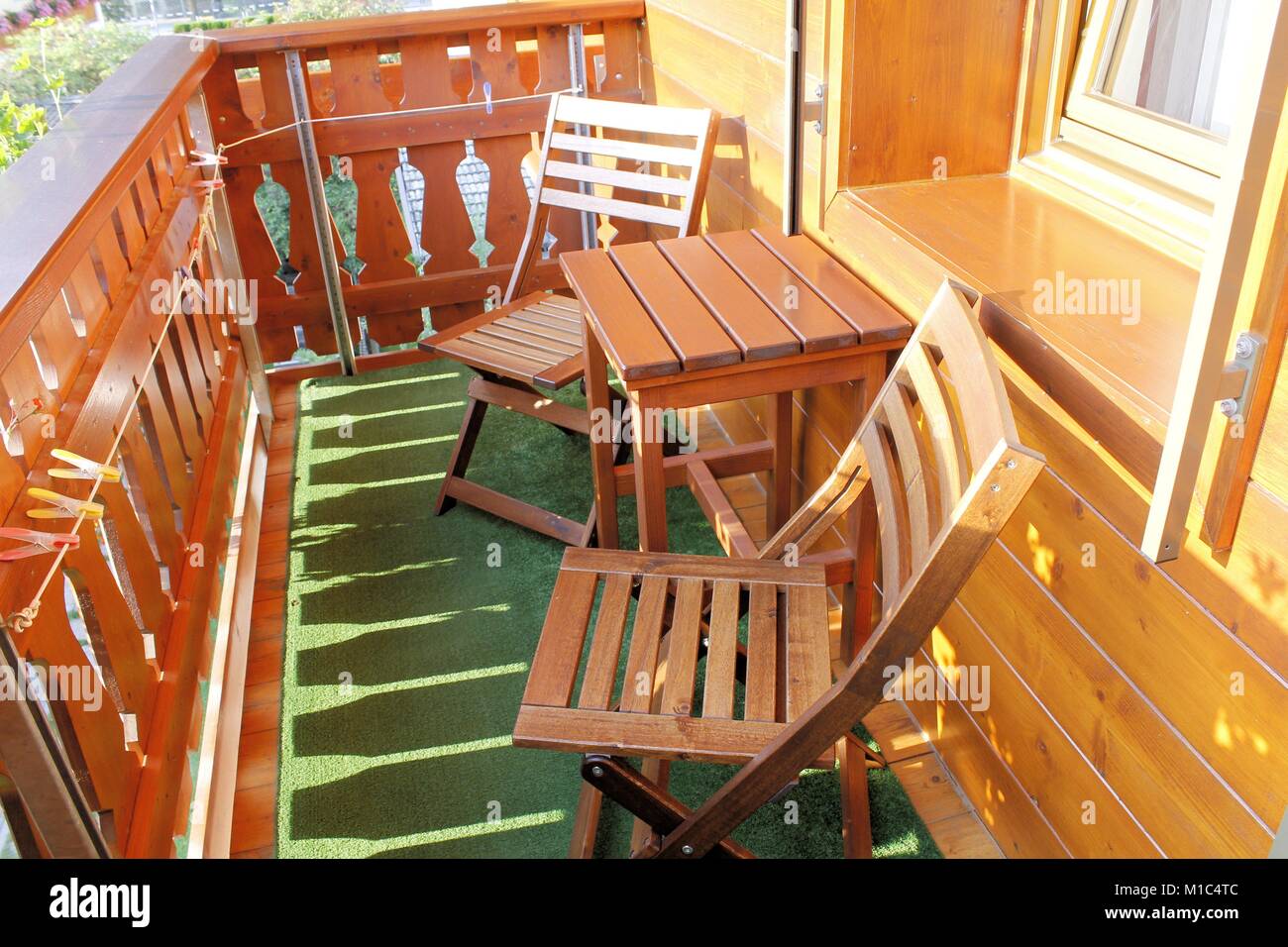 wooden balcony with table and two chairs Stock Photo - Alamy